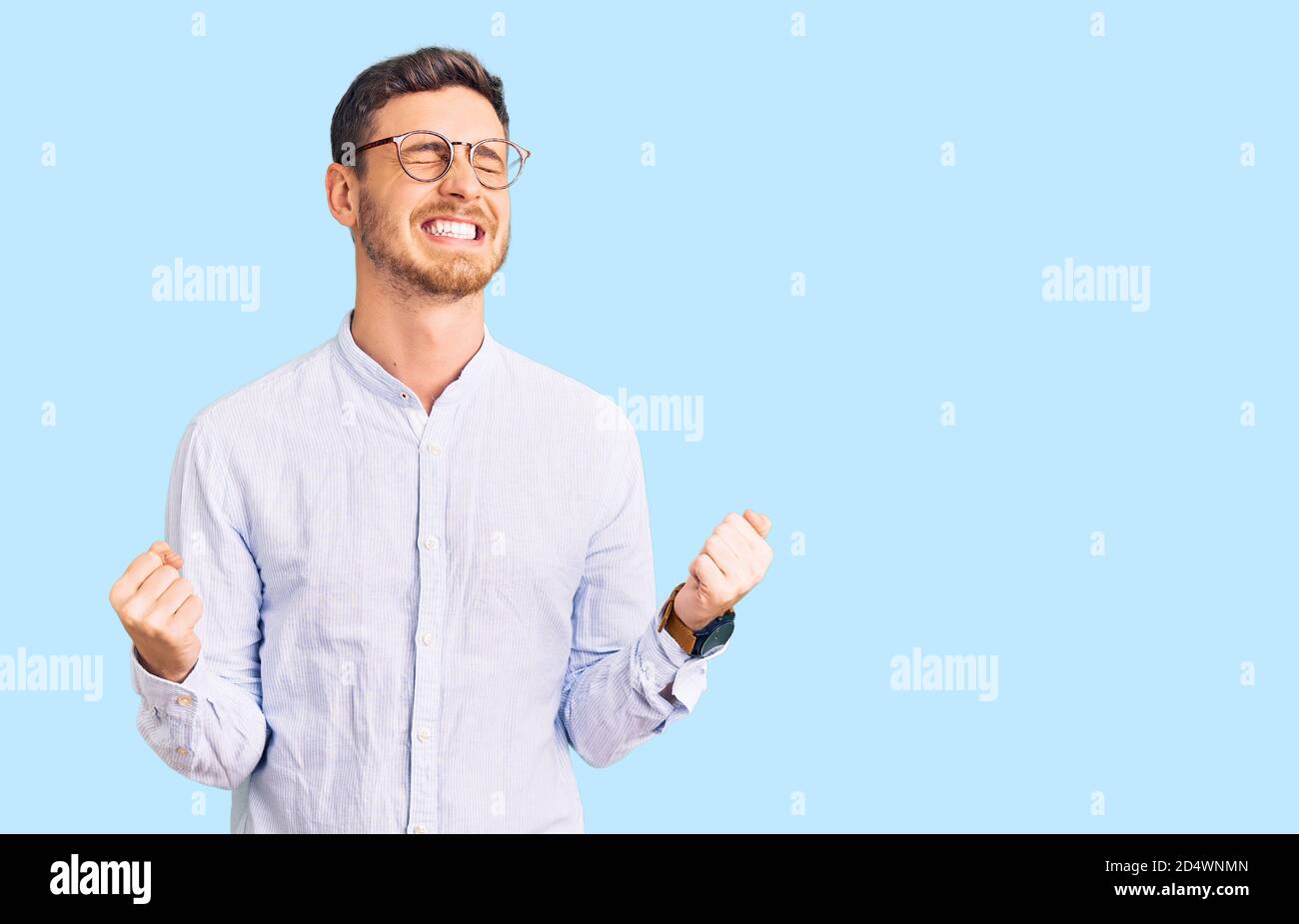 Handsome young man with bear wearing elegant business shirt and glasses ...