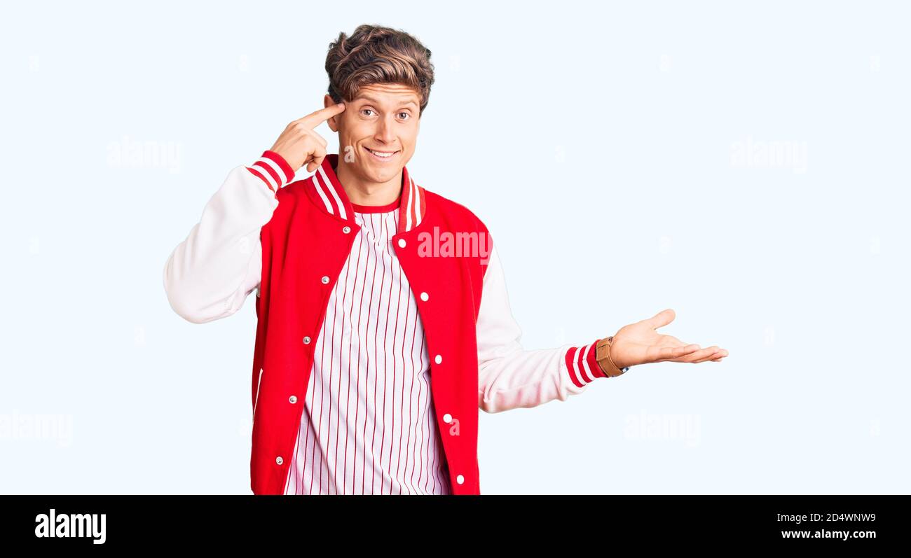 Young handsome man wearing baseball uniform confused and annoyed with ...