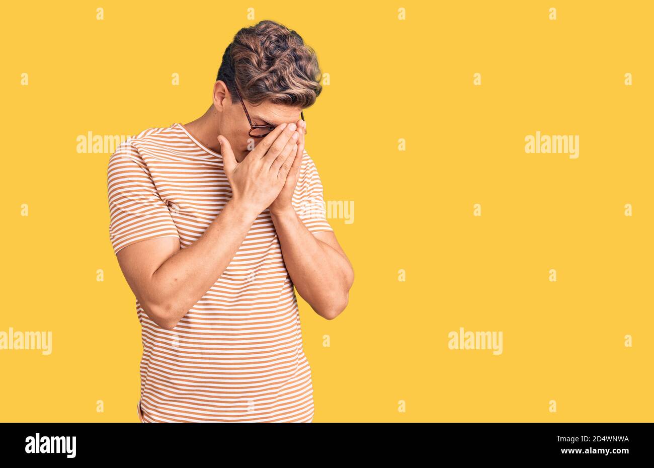 Young handsome man wearing casual clothes and glasses with sad ...
