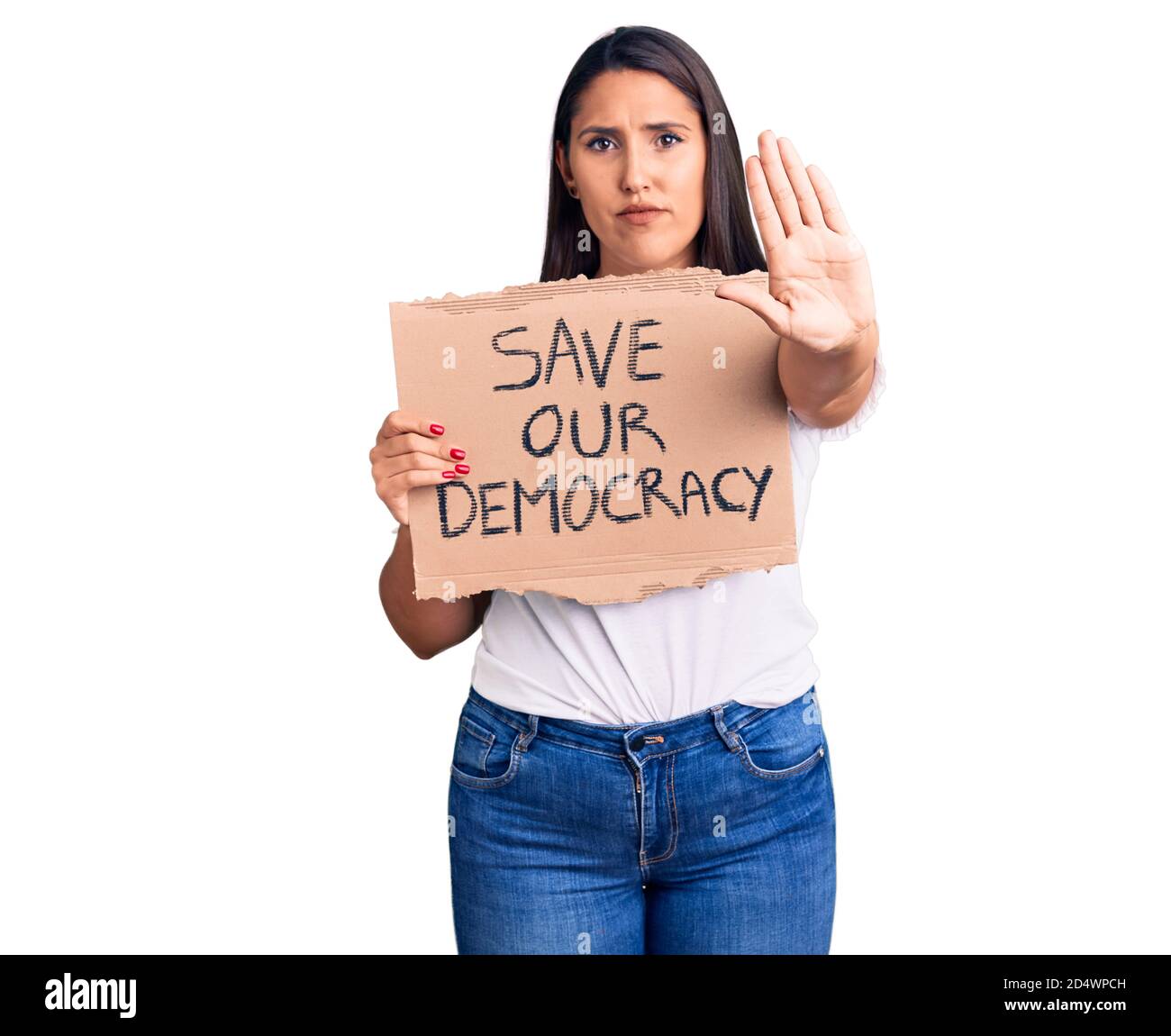 Young beautiful woman holding save our democracy cardboard banner with ...