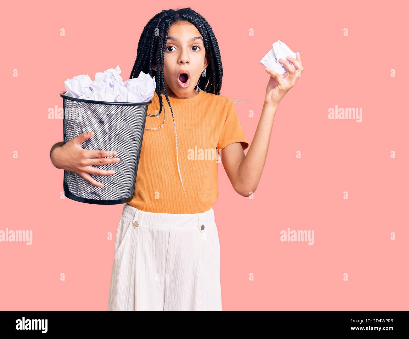 Cute african american girl holding paper bin full of crumpled papers ...