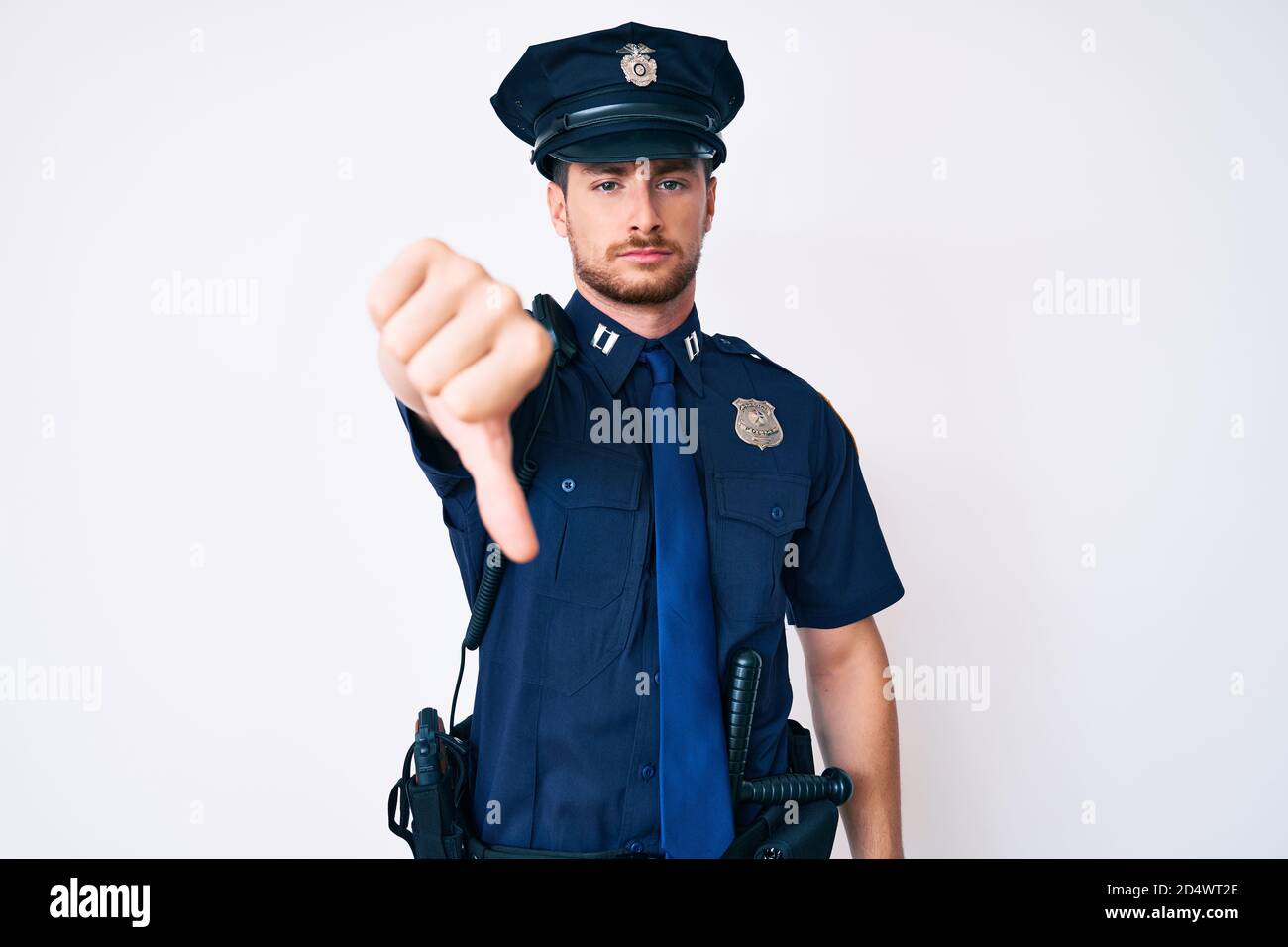 Young caucasian man wearing police uniform looking unhappy and angry ...