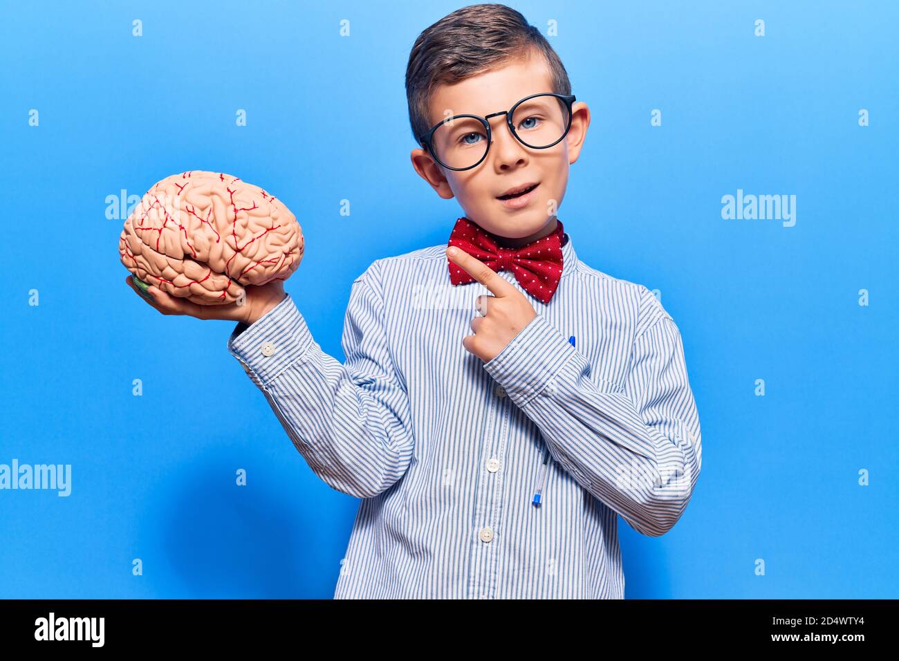 Cute blond kid wearing nerd bow tie and glasses holding brain smiling ...