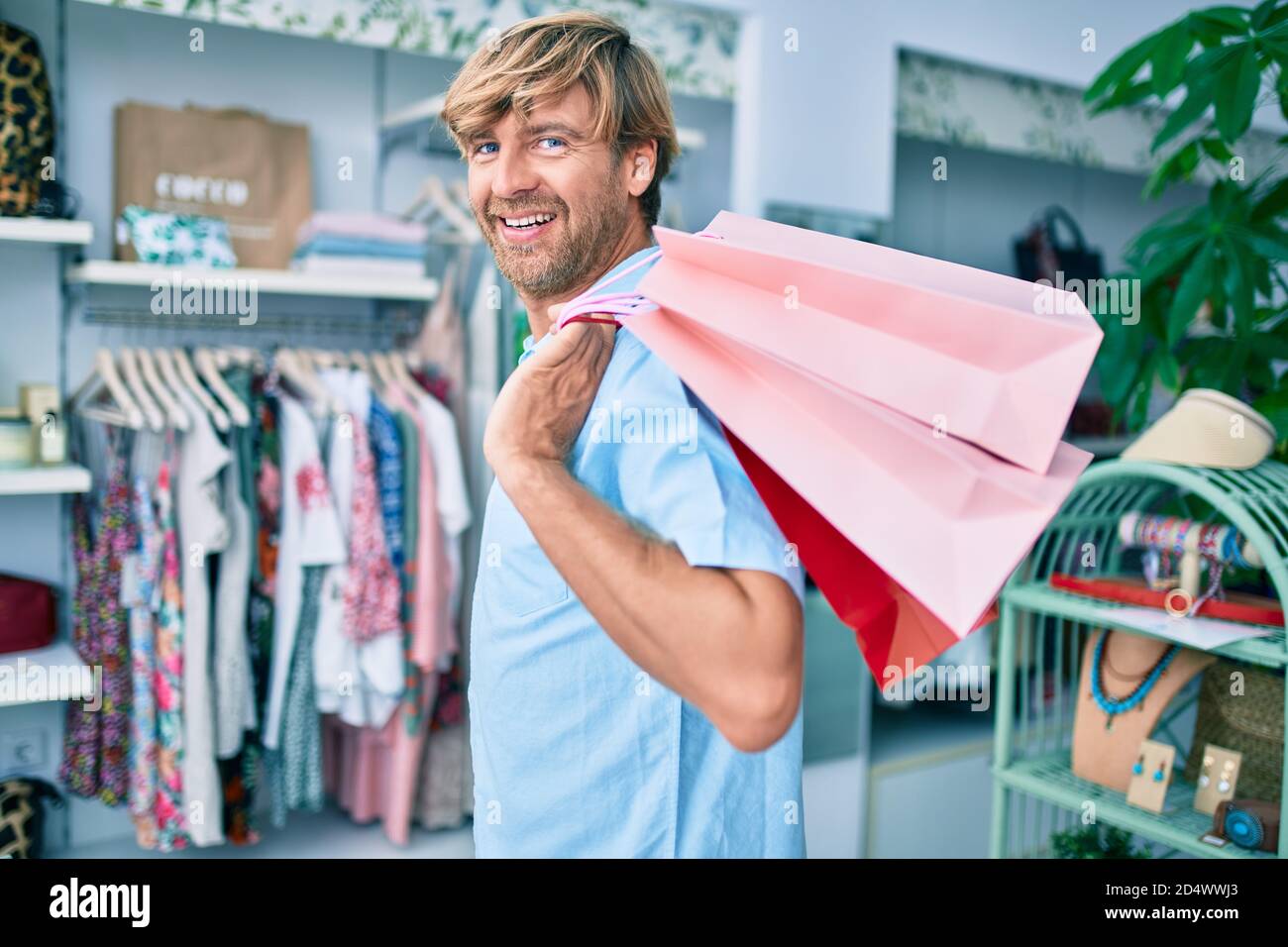 Handsome caucasian man smiling happy shopping on retail shop at the ...