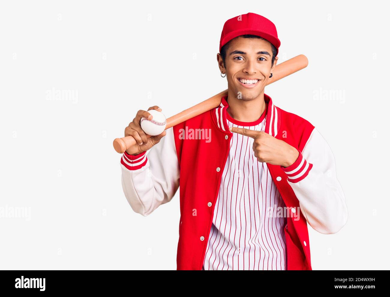 Young african amercian man playing baseball holding bat and ball ...
