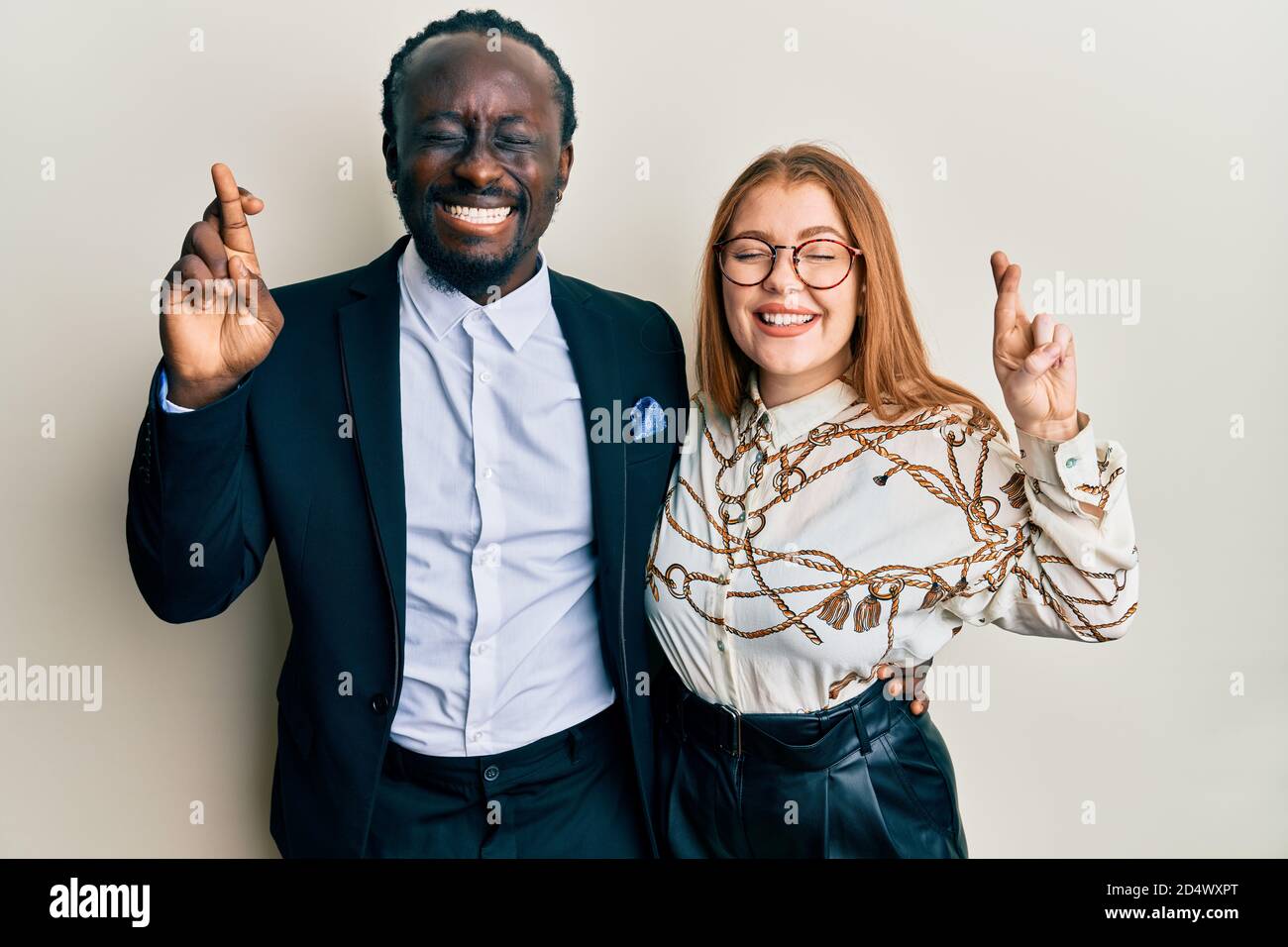 Young Interracial Couple Wearing Business And Elegant Clothes Gesturing
