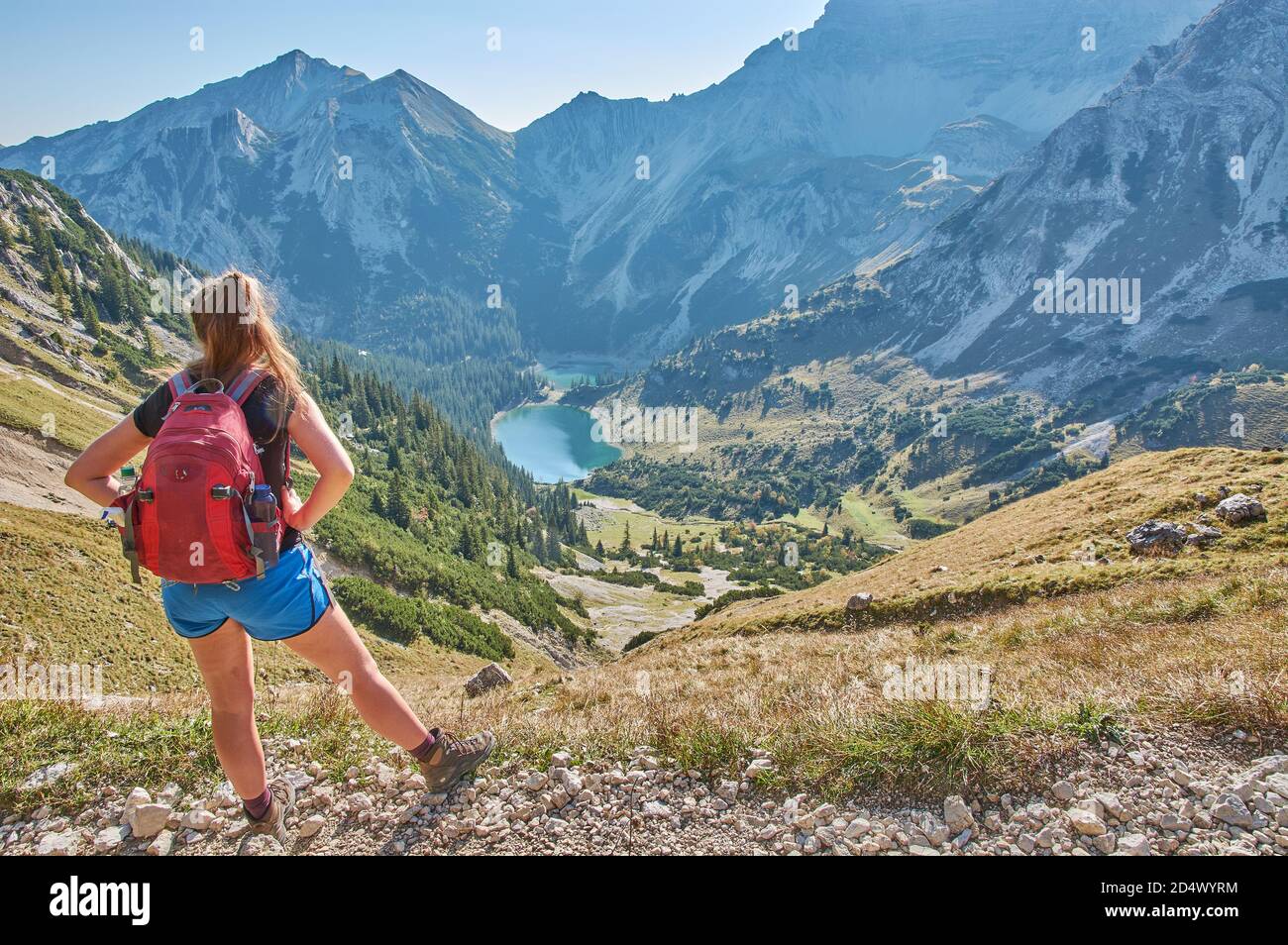 Hiking through the Bavarian alps. Hiker in front of the Soiernsee in ...