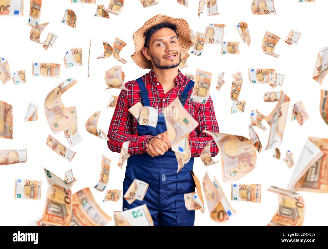 Handsome latin american young man weaing handyman uniform with hands ...