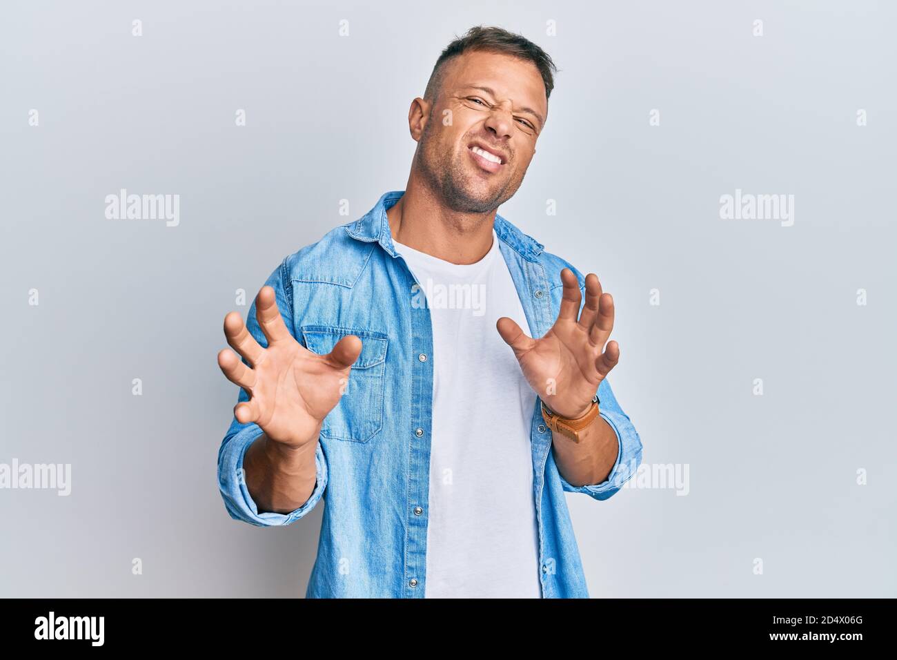 Handsome muscle man wearing casual denim jacket disgusted expression ...