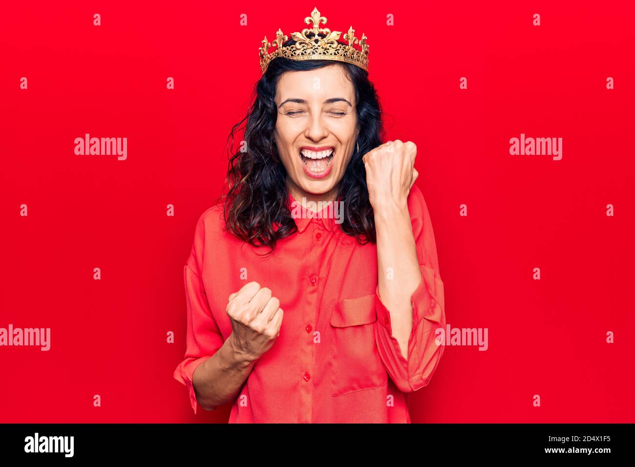Young beautiful hispanic woman wearing princess crown celebrating ...