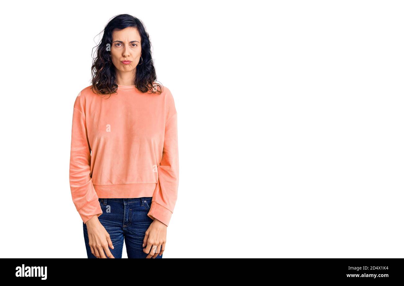 Young beautiful hispanic woman wearing casual clothes depressed and ...