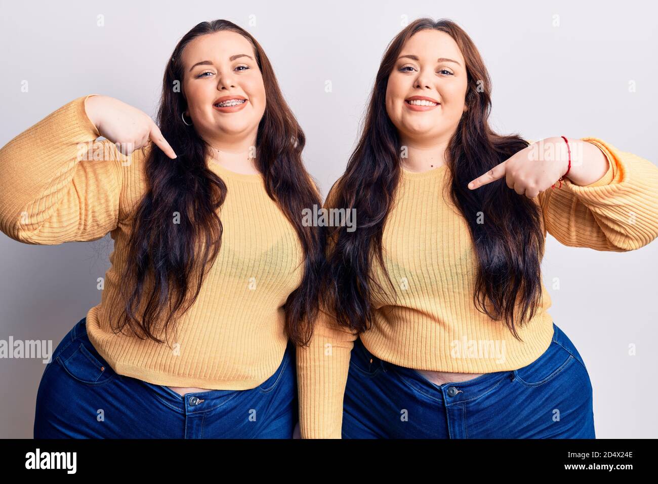Young plus size twins wearing casual clothes looking confident with ...