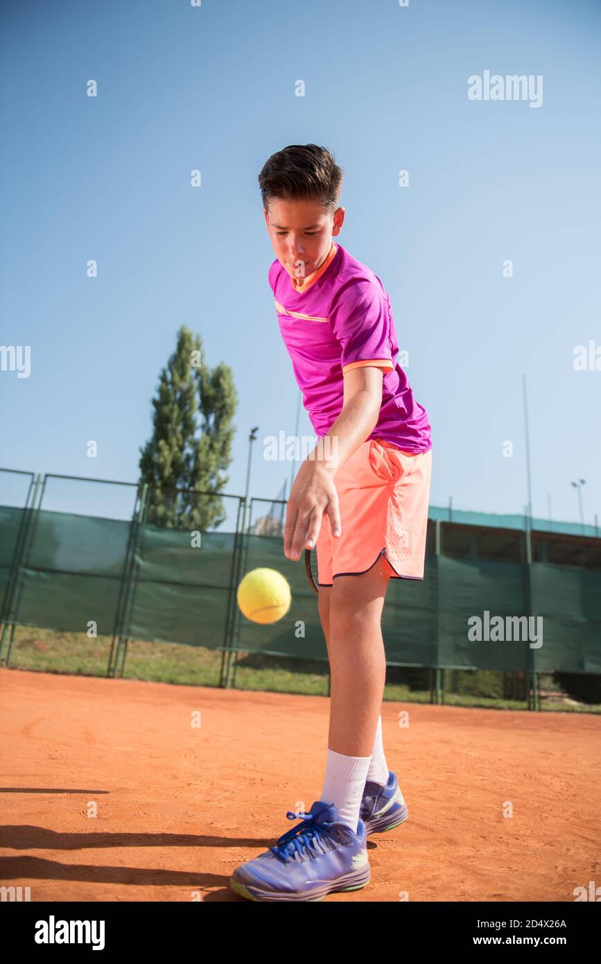 Young tennis player prepares for serving the ball Stock Photo - Alamy