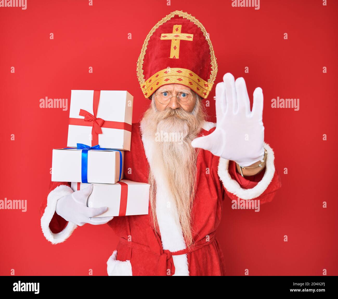 Old senior man with grey hair and long beard wearing saint nicholas ...