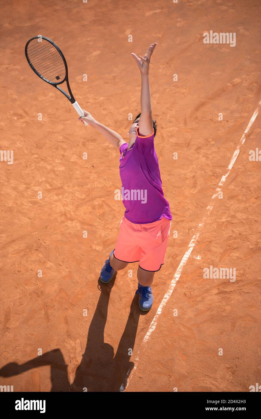 Young tennis player serving the ball Stock Photo - Alamy