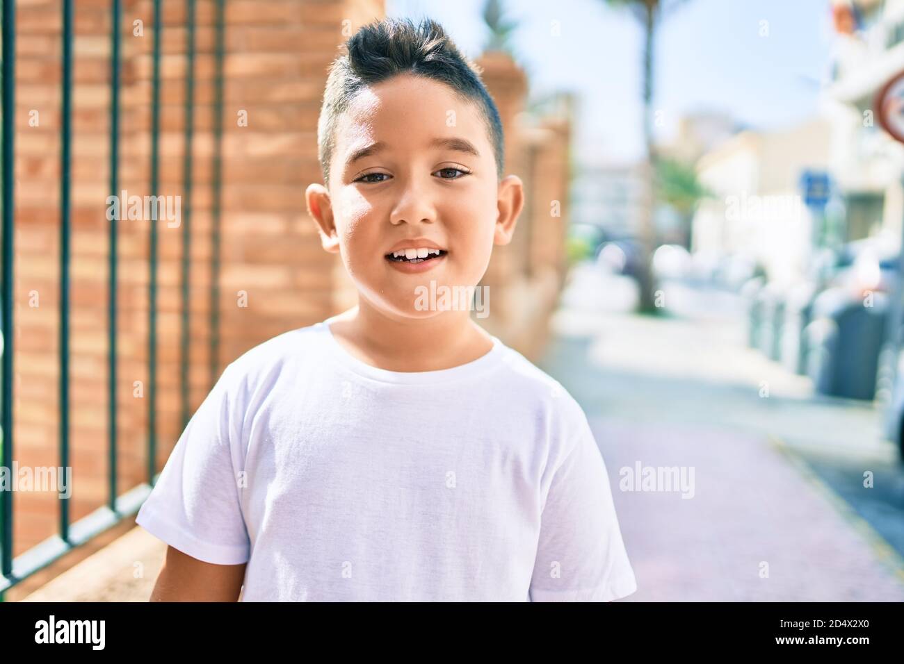 Adorable boy smiling happy standing at street of city Stock Photo - Alamy