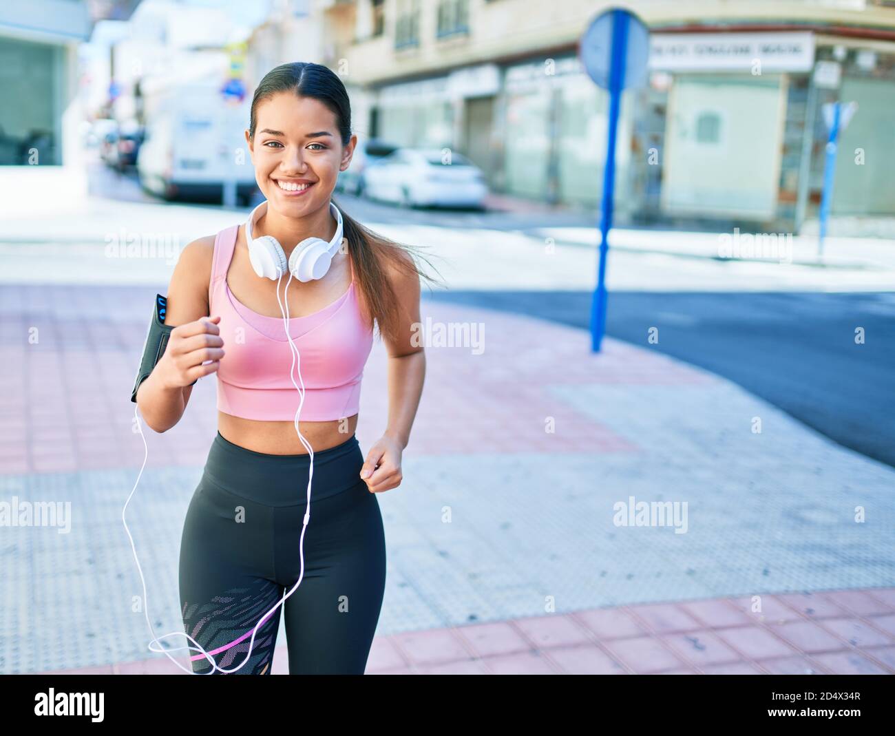 Young beautiful hispanic sport woman wearing runner outfit and ...