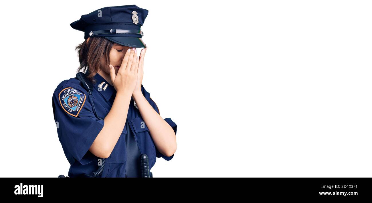 Young beautiful girl wearing police uniform with sad expression ...