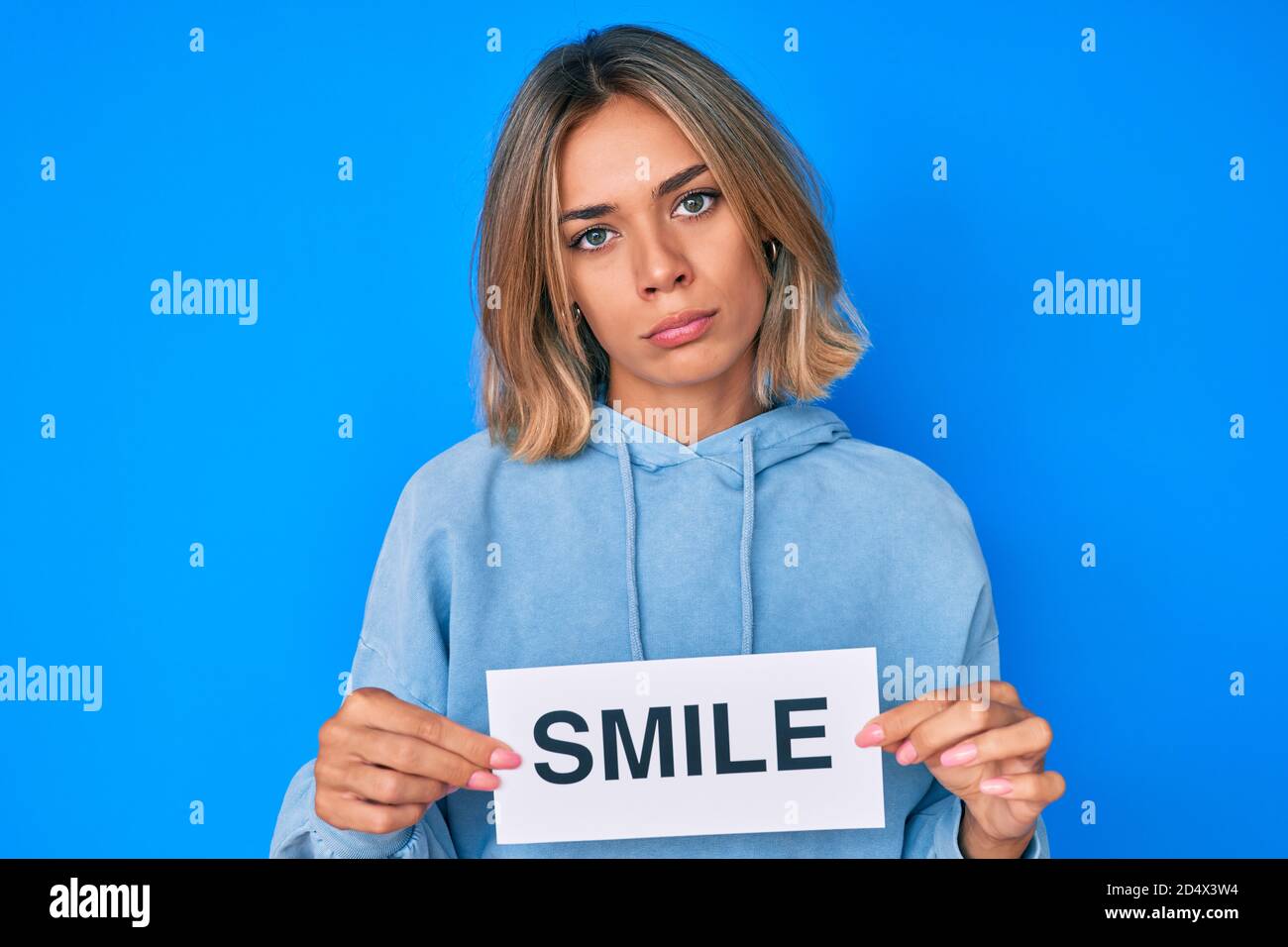 Beautiful caucasian woman holding smile text depressed and worry for ...