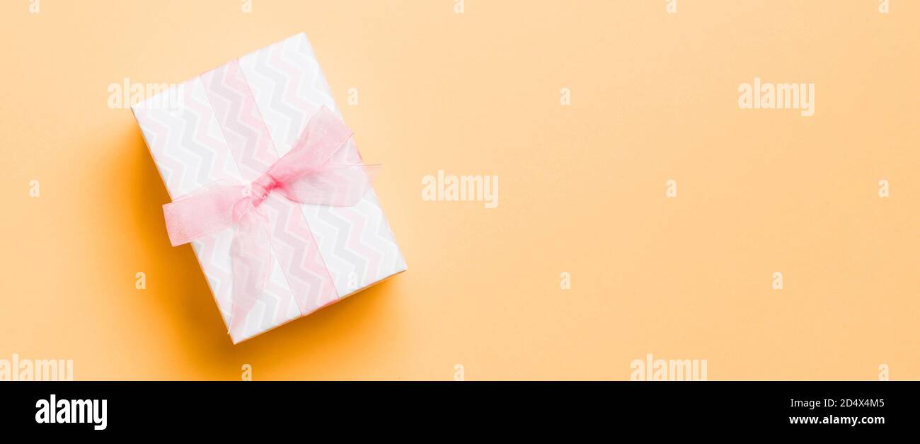 wrapped Christmas or other holiday handmade present in paper with pink ...