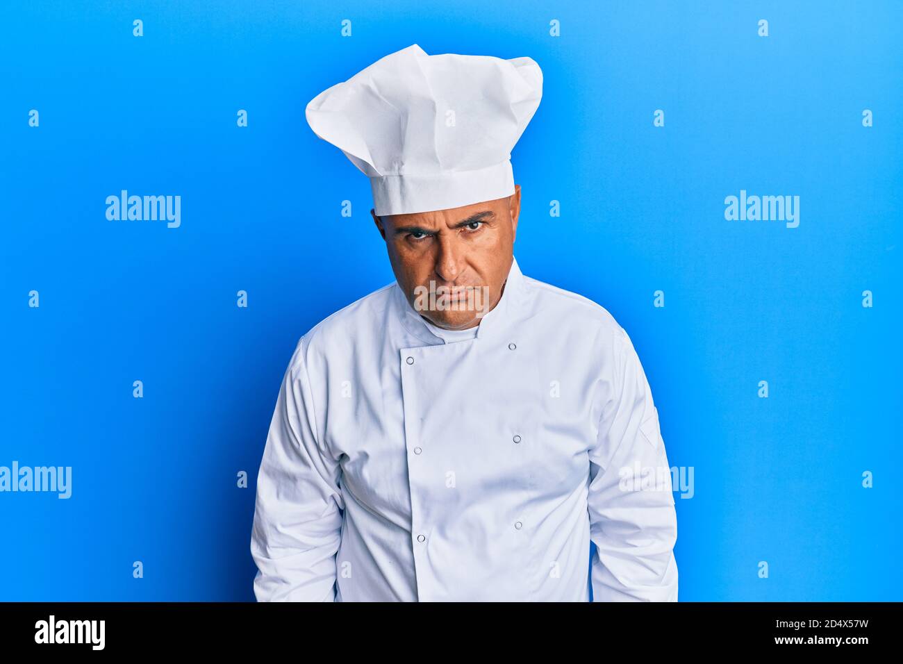Mature middle east man wearing professional cook uniform and hat ...