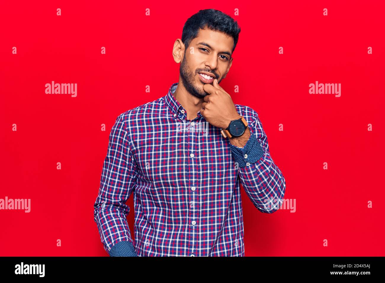 Young latin man wearing casual clothes smiling looking confident at the ...