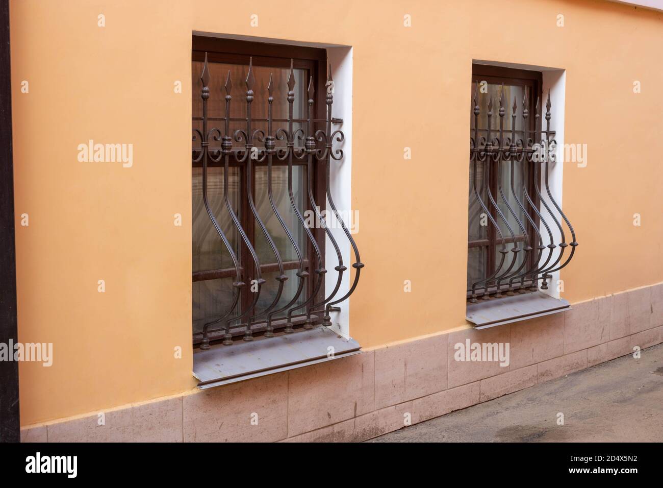 Facade on the side. Windows with iron bars with the ligature Stock ...