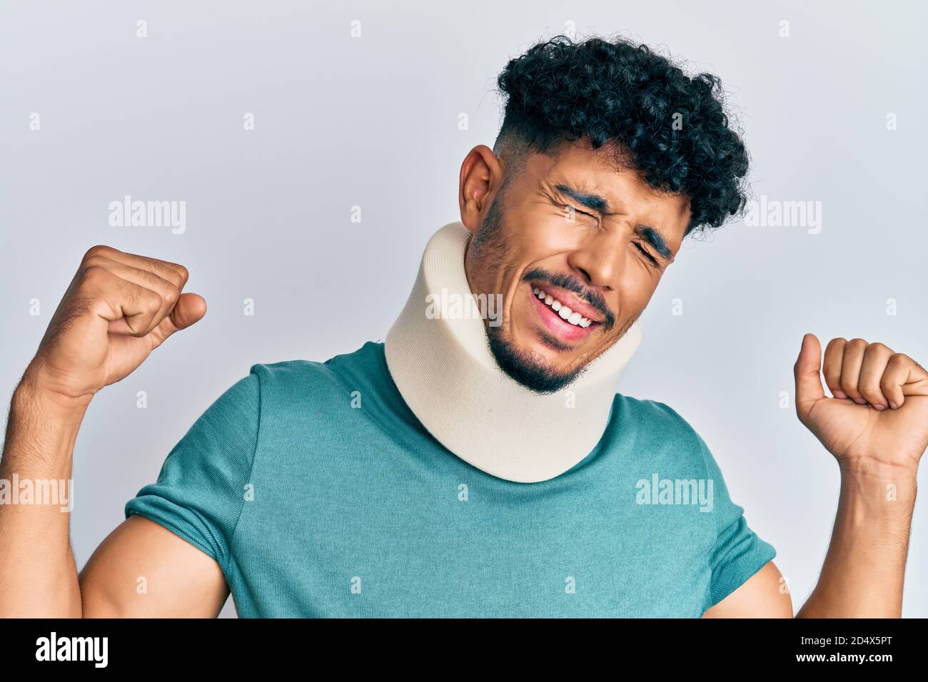 Young arab handsome man wearing cervical neck collar very happy and ...