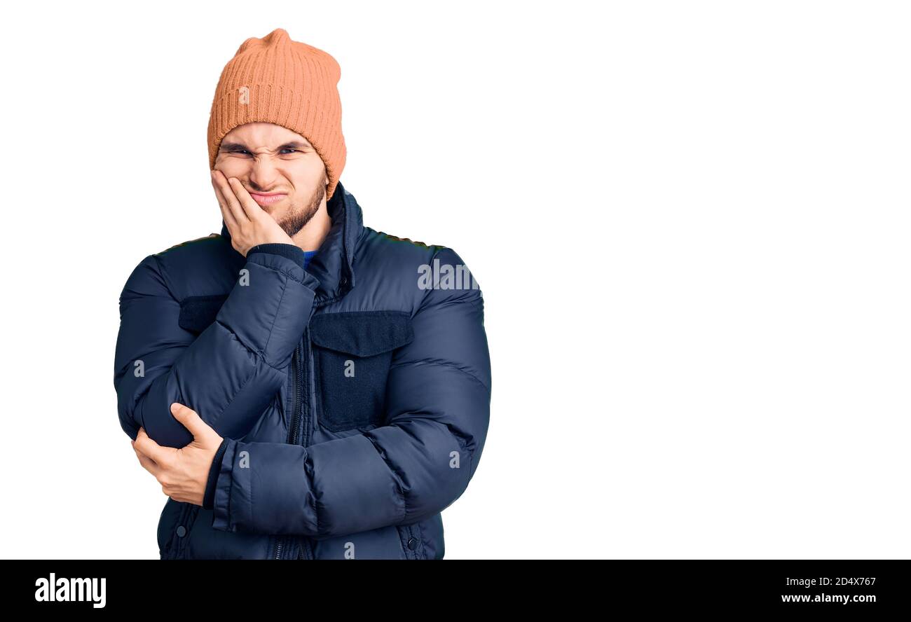 Young handsome man wearing winter clothes thinking looking tired and ...