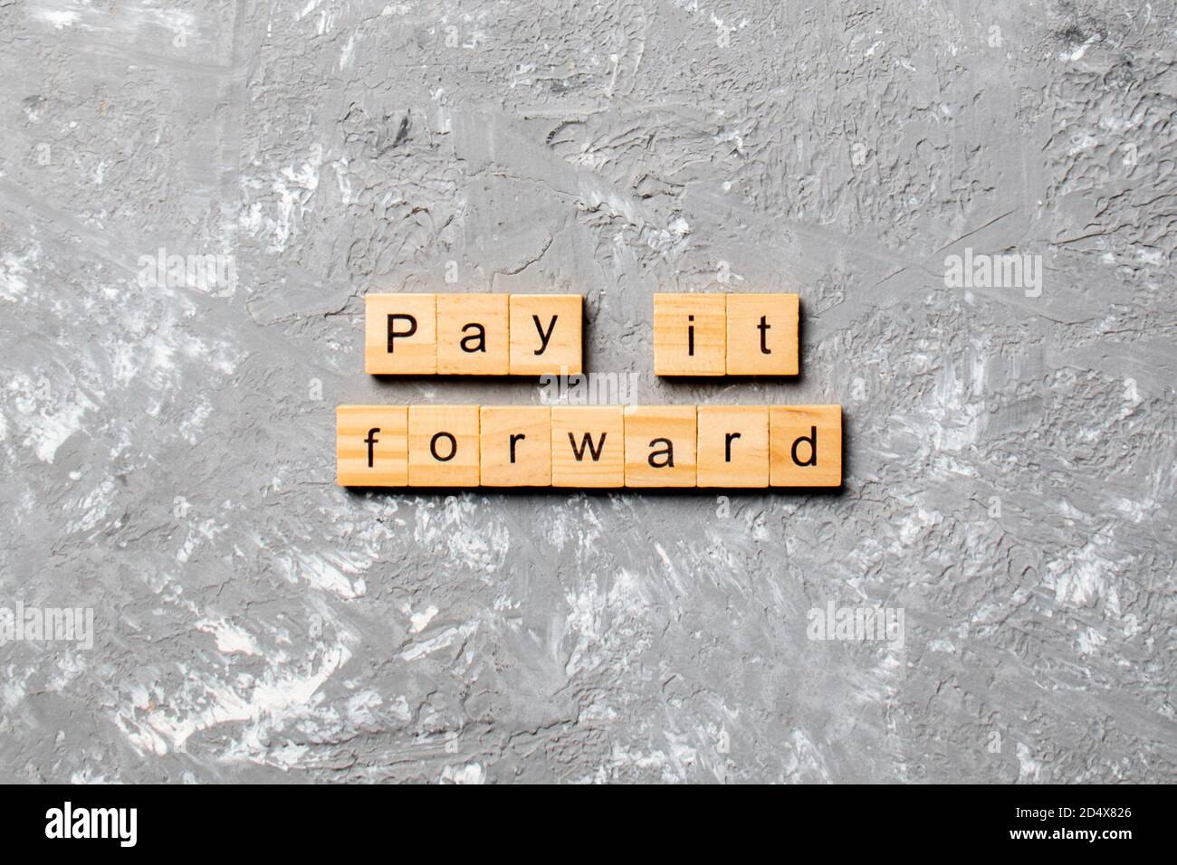 Pay It Forward word written on wood block. Pay It Forward text on ...
