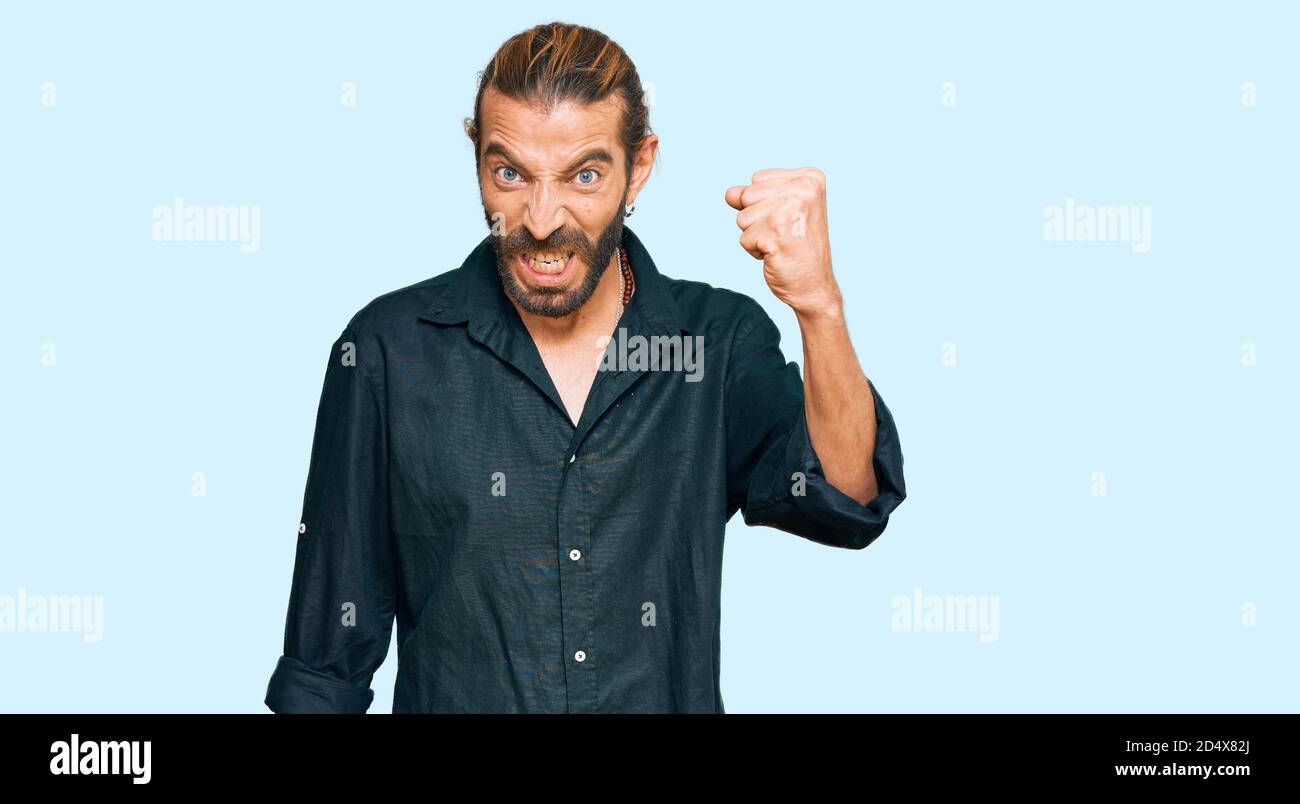 Attractive man with long hair and beard wearing casual clothes annoyed ...