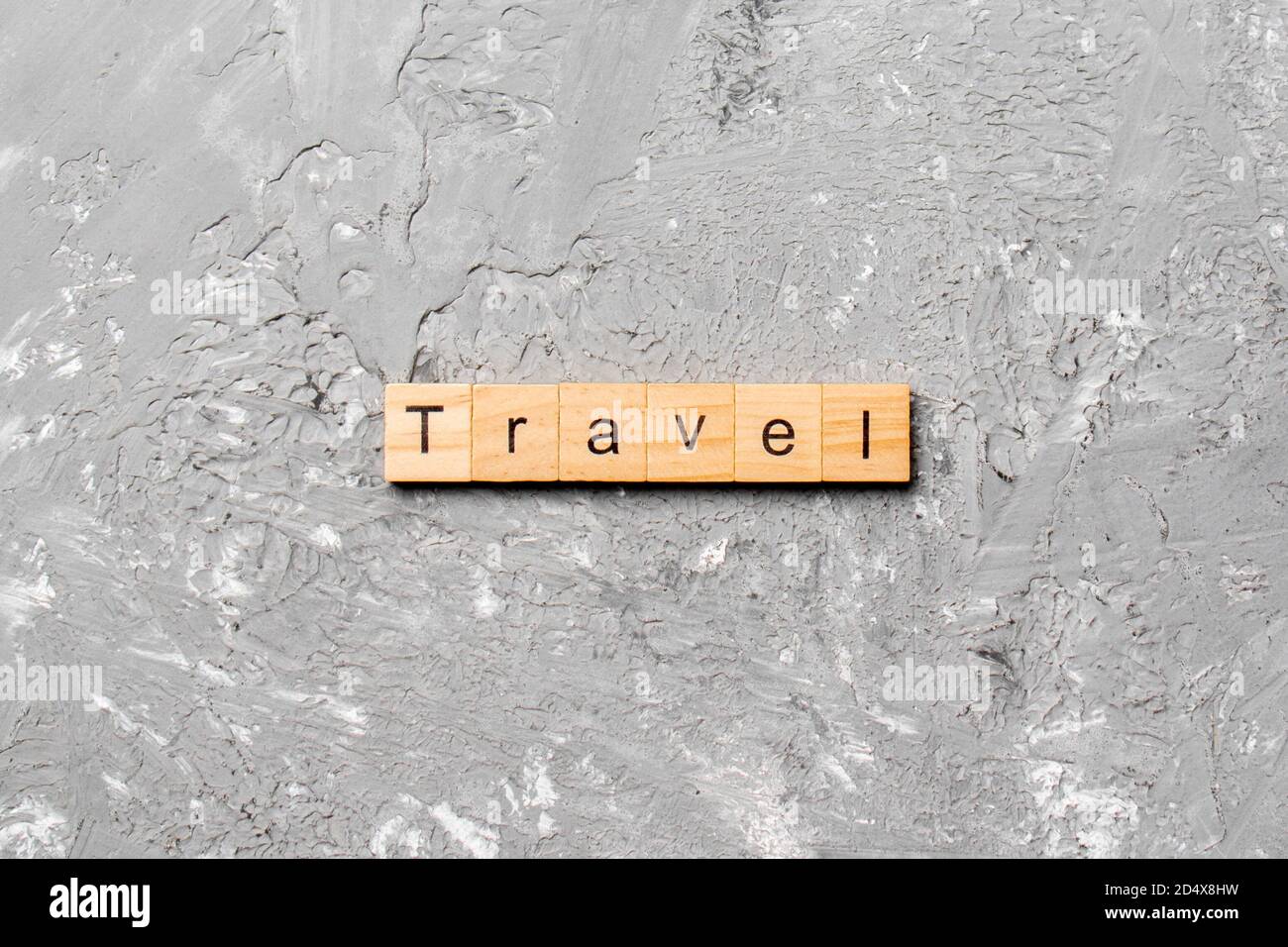 Travel word written on wood block. Travel text on cement table for your ...