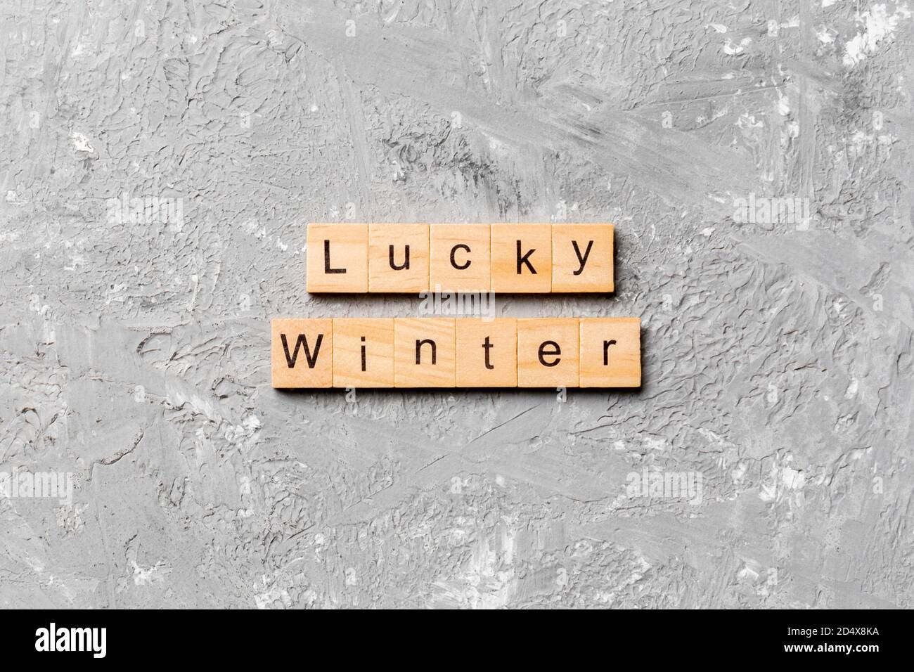 lucky winter word written on wood block. lucky winter text on cement ...