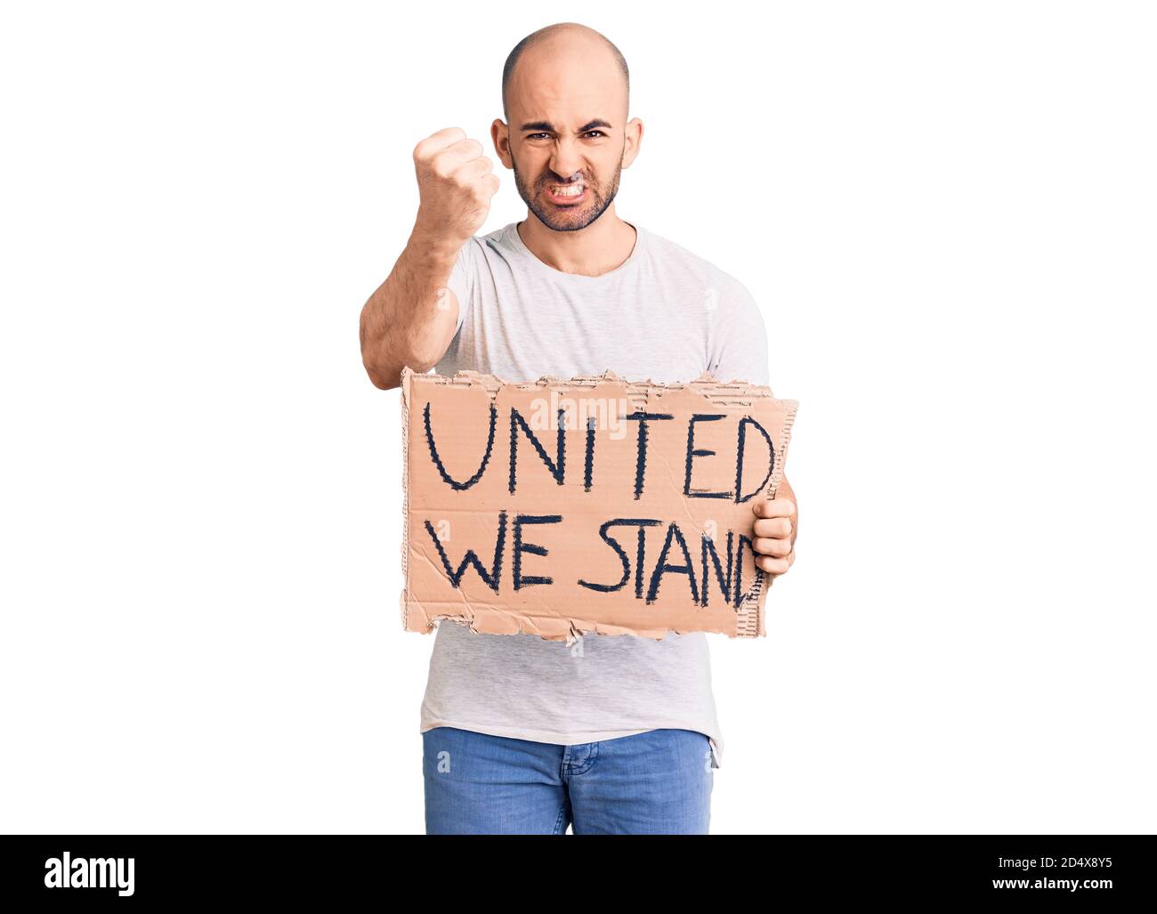 Young handsome man holding united we stand banner annoyed and ...
