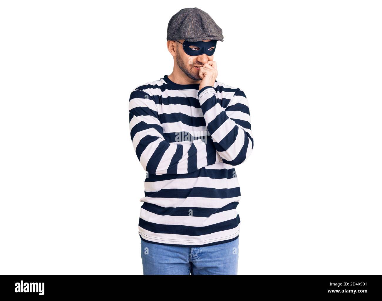 Young handsome man wearing burglar mask looking stressed and nervous ...