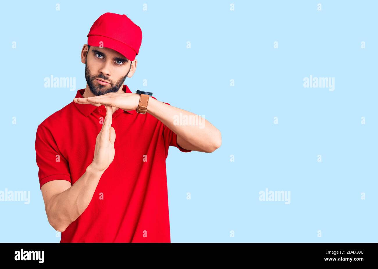 Young Handsome Man With Beard Wearing Delivery Uniform Doing Time Out