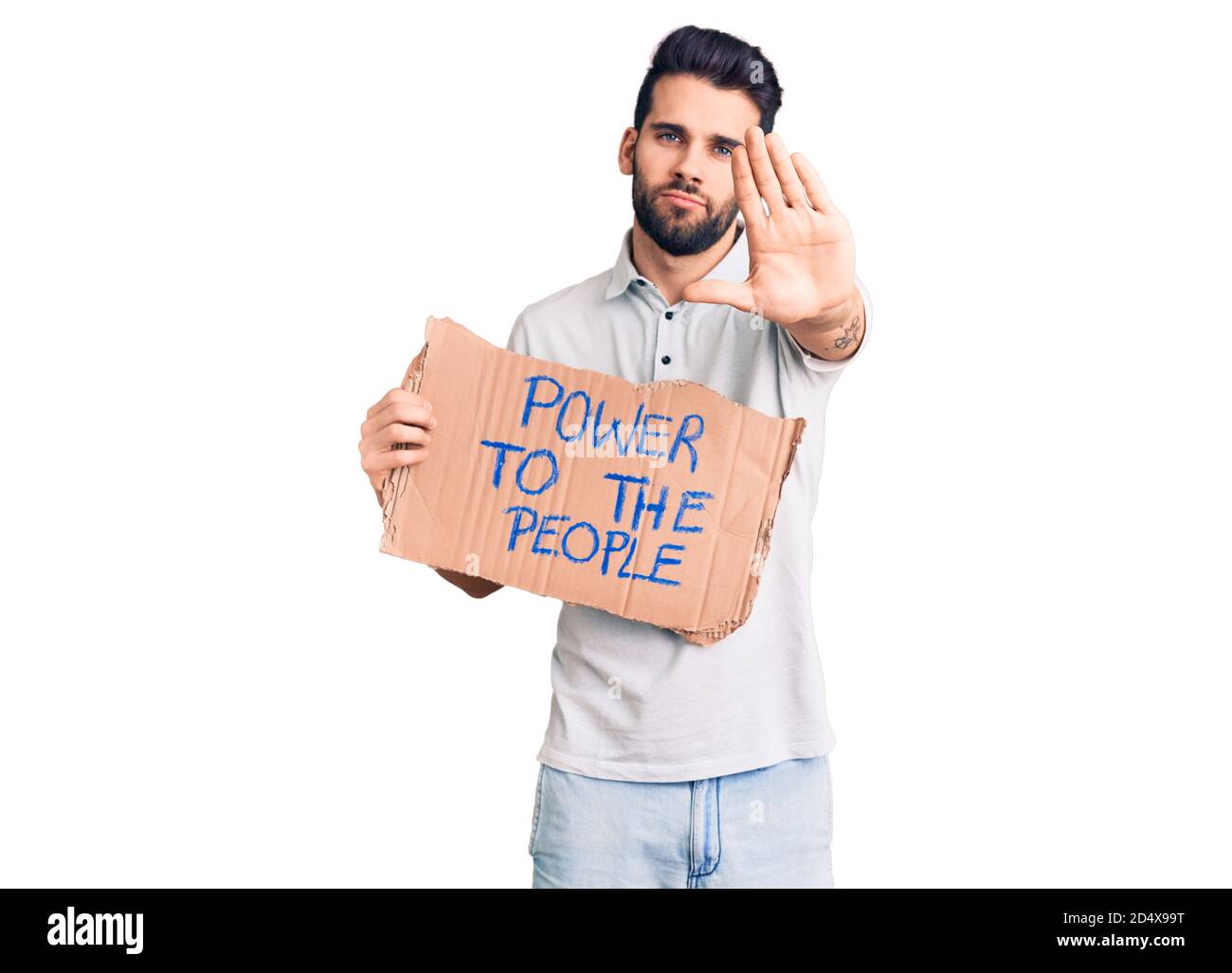 Young handsome man with beard holding power to the people cardboard ...