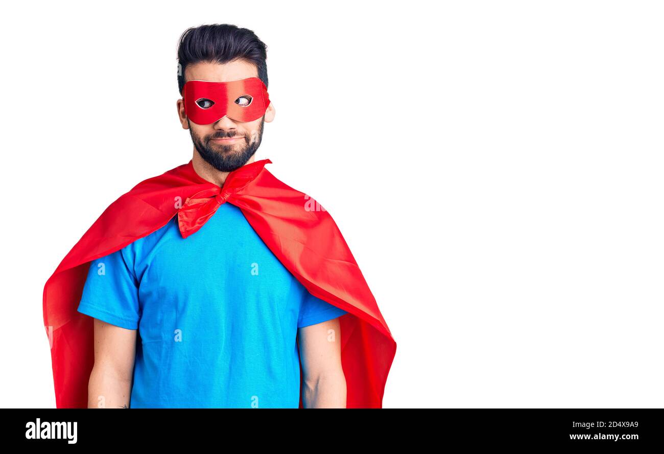 Young handsome man with beard wearing super hero costume smiling ...