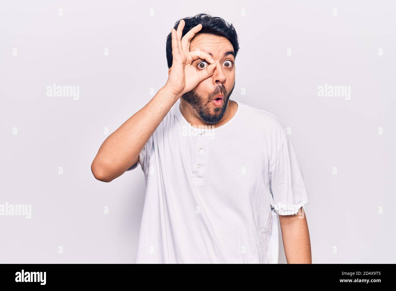 Young hispanic man wearing casual clothes doing ok gesture shocked with ...