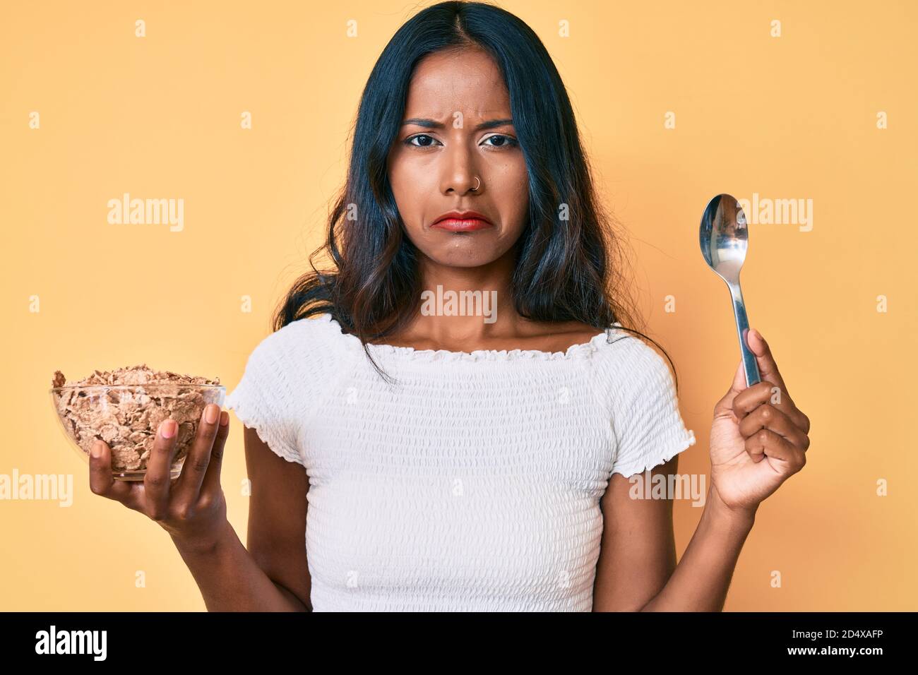 Young indian girl eating healthy whole grain celears depressed and ...