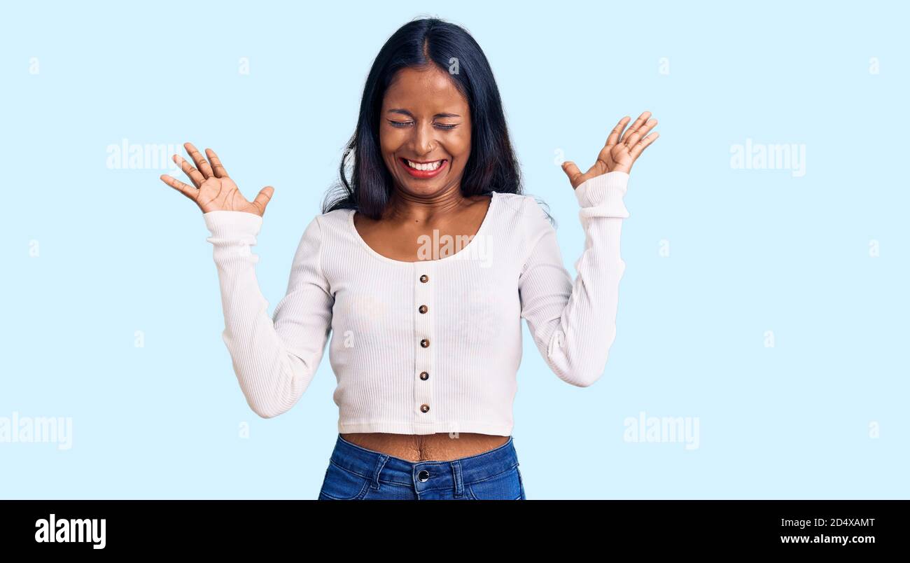 Young indian girl wearing casual clothes celebrating mad and crazy for ...