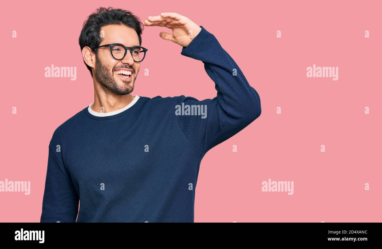 Young hispanic man wearing casual clothes and glasses very happy and ...