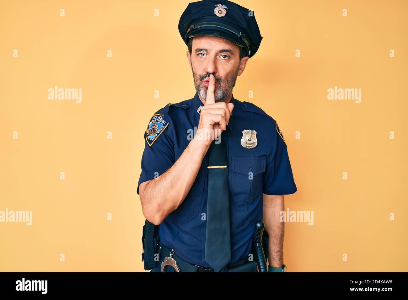 Middle age hispanic man wearing police uniform asking to be quiet with ...