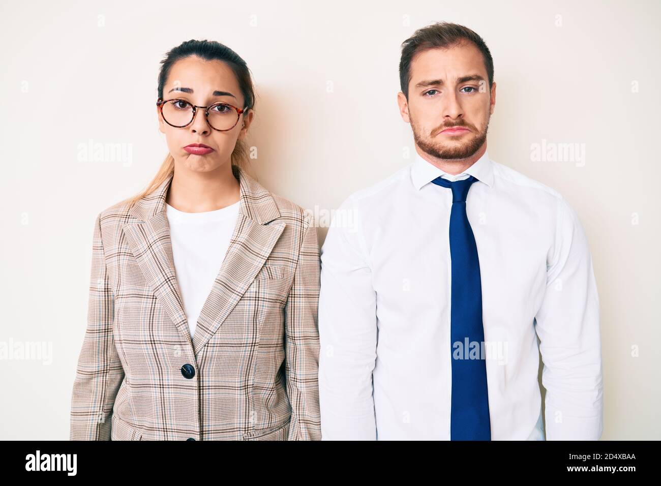 Beautiful couple wearing business clothes depressed and worry for ...