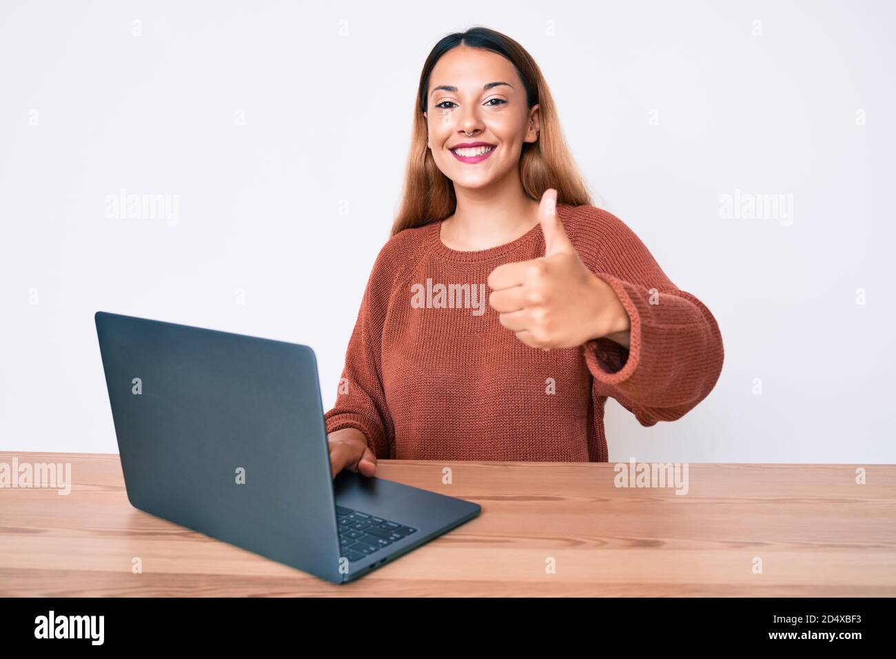 Young brunette woman working using computer laptop smiling happy and ...
