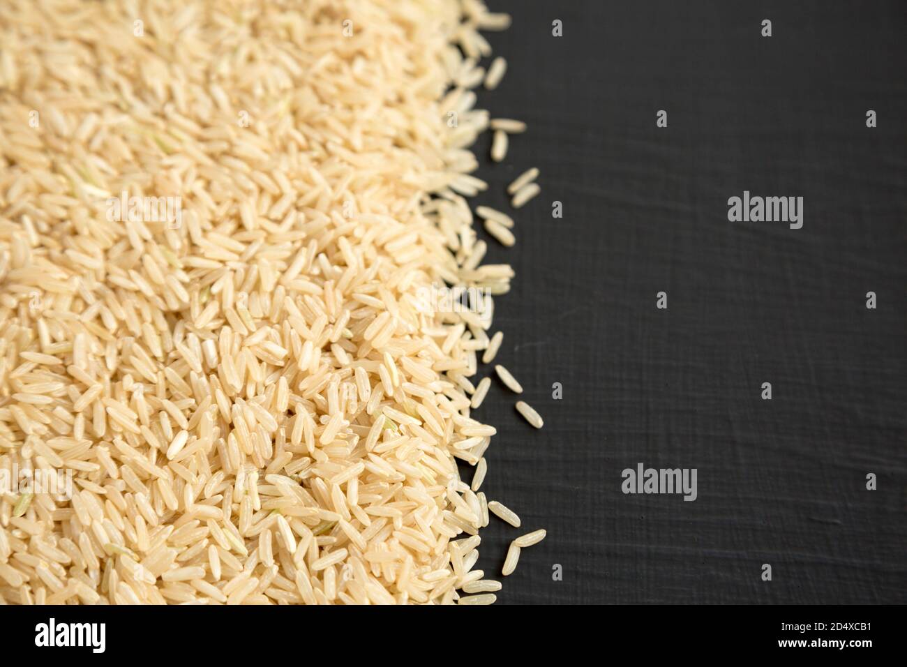Dry Brown Rice background, side view. Copy space Stock Photo - Alamy