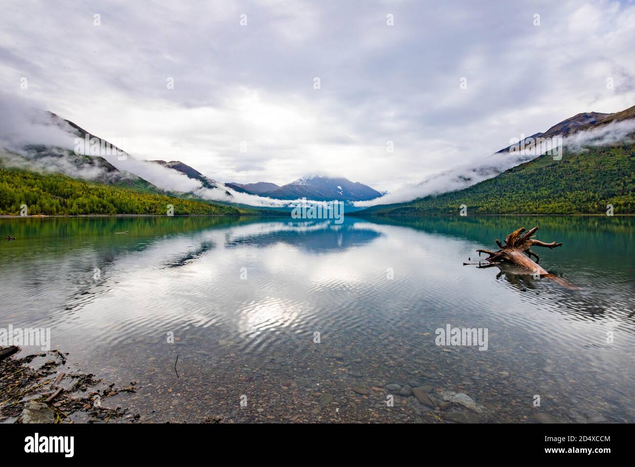 Alaska northern lake with snow mountains in the back water reflection ...