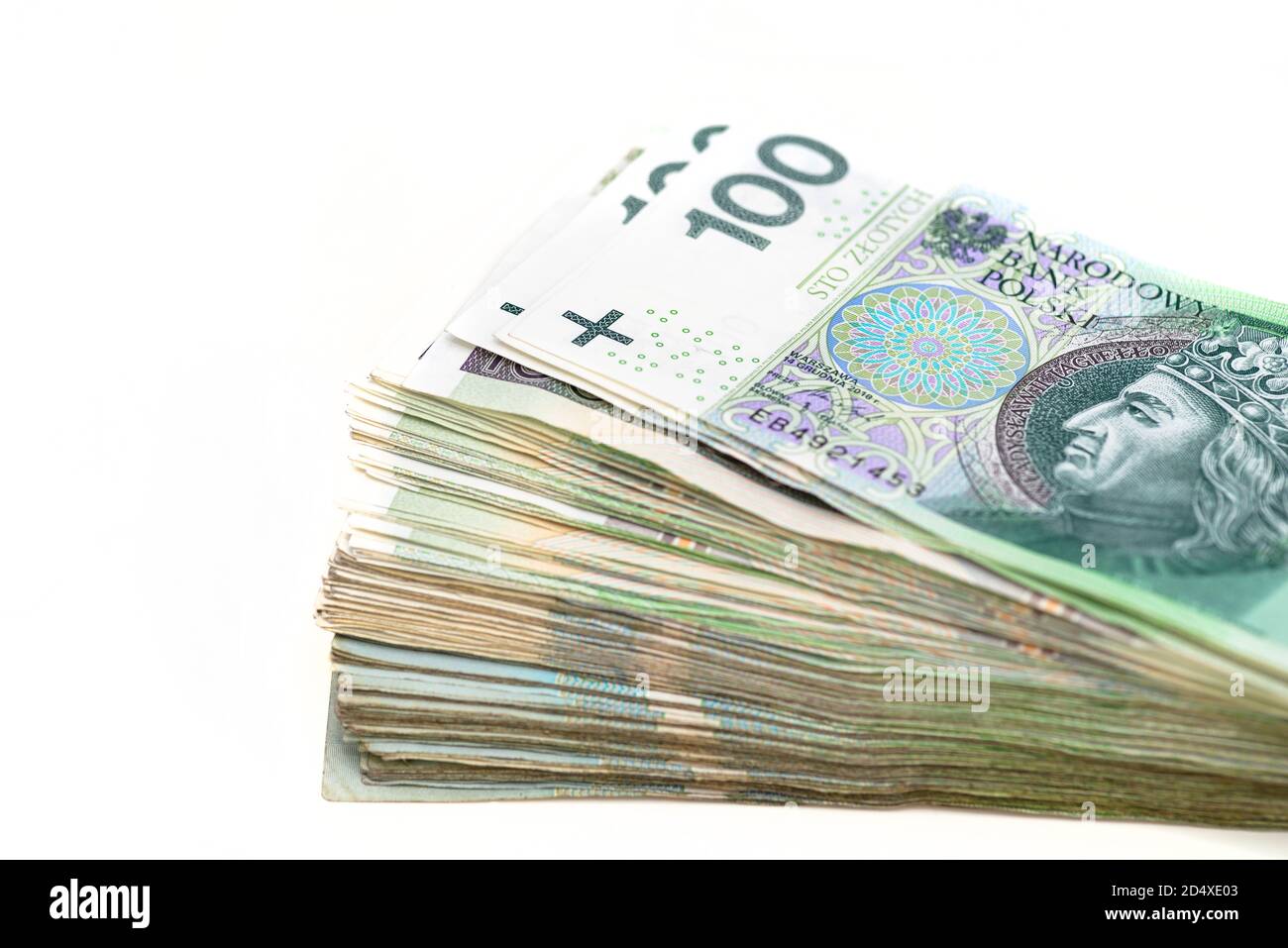 A pile of stacked 100 Polish zloty paper banknotes, isolated on a white ...