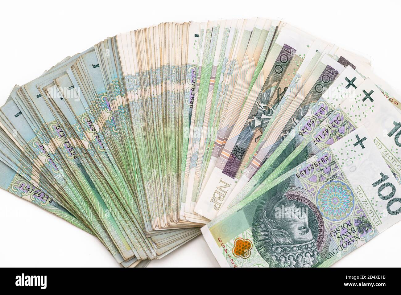 A pile of scattered 100 Polish zloty paper banknotes, isolated on a ...