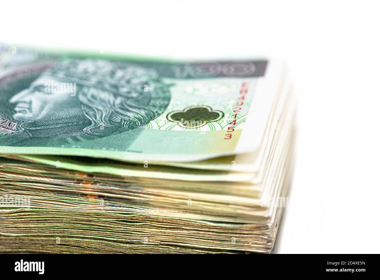 A pile of stacked 100 Polish zloty paper banknotes, isolated on a white ...